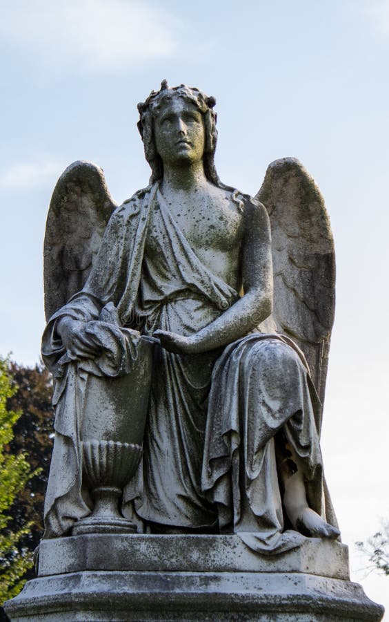 Vertical Shot of an Old Weathered Angel Statue in a Graveyard Editorial ...