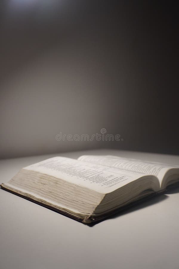 Vertical Shot of the Open Bible on the White Table Stock Photo - Image ...