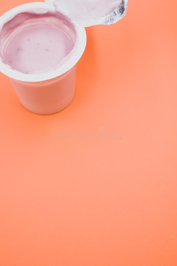 Vertical Shot of an Opened Fruit Yogurt on an Orange Surface Stock ...