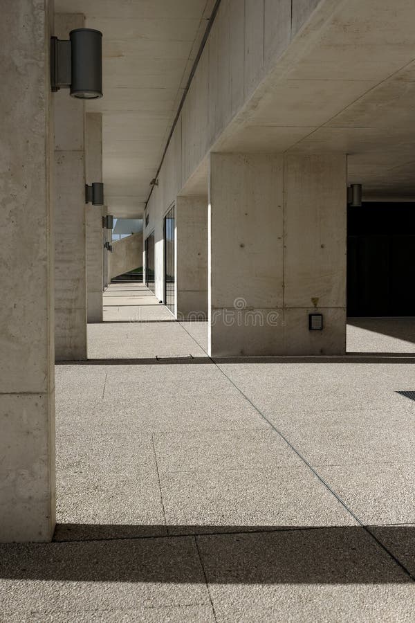 Vertical Shot of an Outdoor Corridor in a Building with White Columns ...