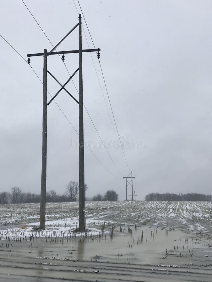Vertical Shot of Overhead Power Lines in the Valley on a Dark Gloomy ...