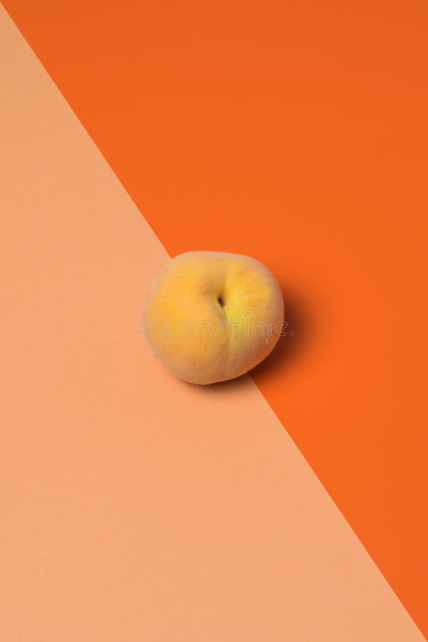 Orange Split in Half with a Straw Simulating a Soft Drink on a Yellow ...