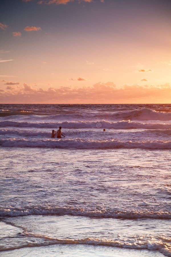 Vertical Shot of People Having Fun in Sea at Sunset Stock Image - Image ...
