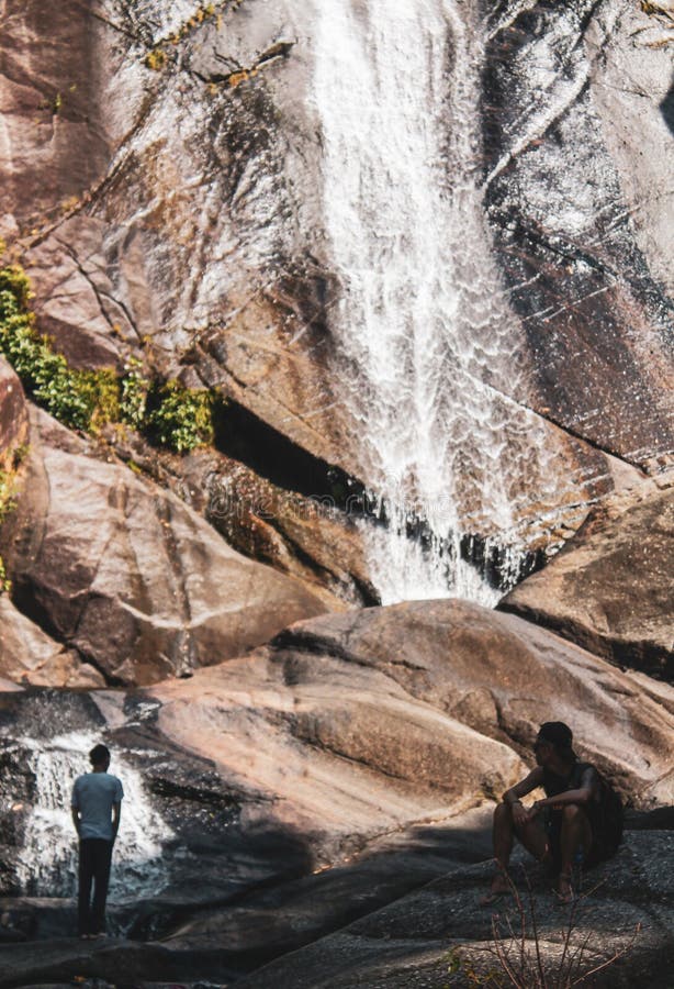 Vertical Shot of People Near the Beautiful Waterfall Stock Image ...