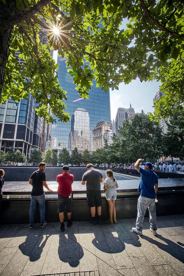 Vertical Shot of People Standing in Front of New York Buildings ...