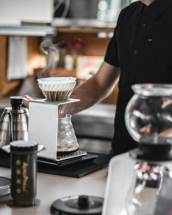 Vertical Shot of a Person Brewing Coffee in a Coffee Shop Stock Photo ...