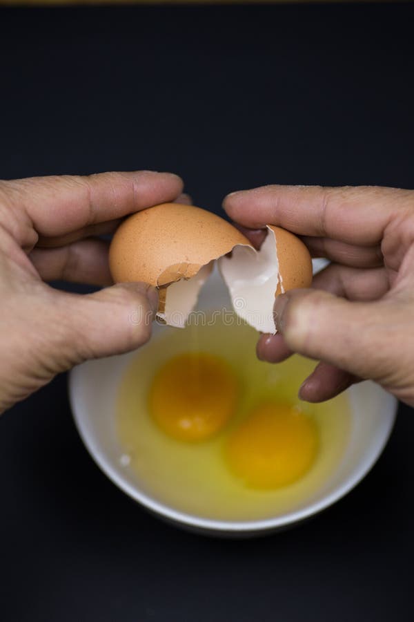 A Person Cracking an Egg into a Bowl. Stock Image - Image of person ...