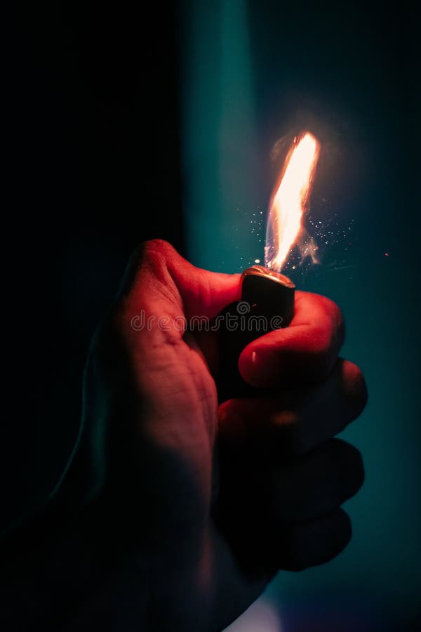 Vertical Shot of a Person Hand Holding a Lit Lighter Stock Image ...