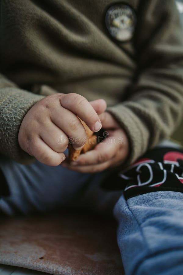 Vertical Shot of a Person with His Face Above the View Holding Crackers ...