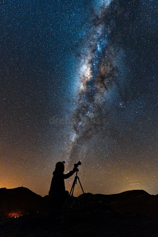 Vertical Shot of a Person in Shadow with a Telescope Looking at Starry ...