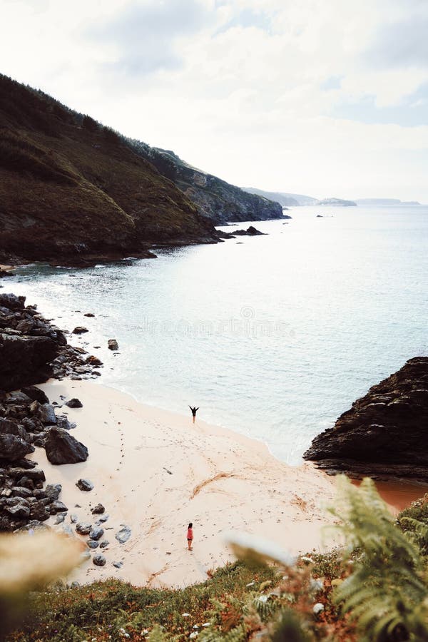 Vertical Shot of a Person Standing on a Cliff -the Concept of Freedom ...