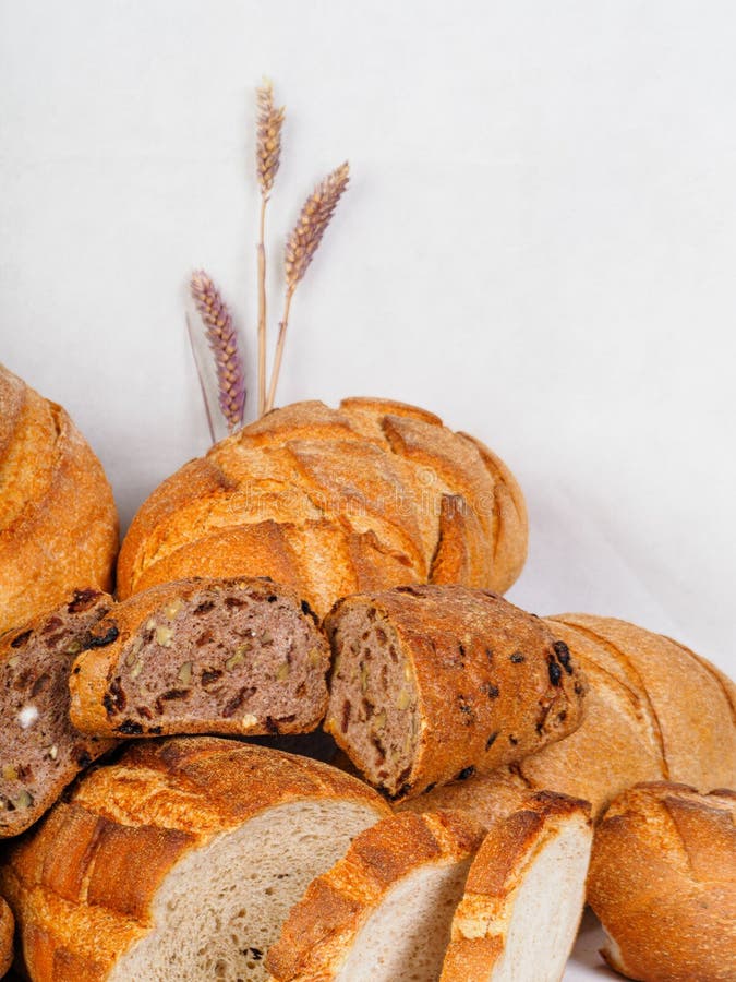 Vertical Shot of Pieces of Assorted Bread on a White Background Stock ...