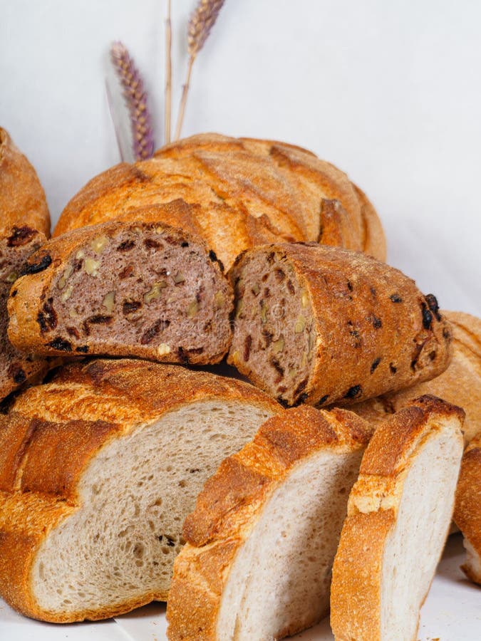 Vertical Shot of Pieces of Assorted Bread on a White Background Stock ...