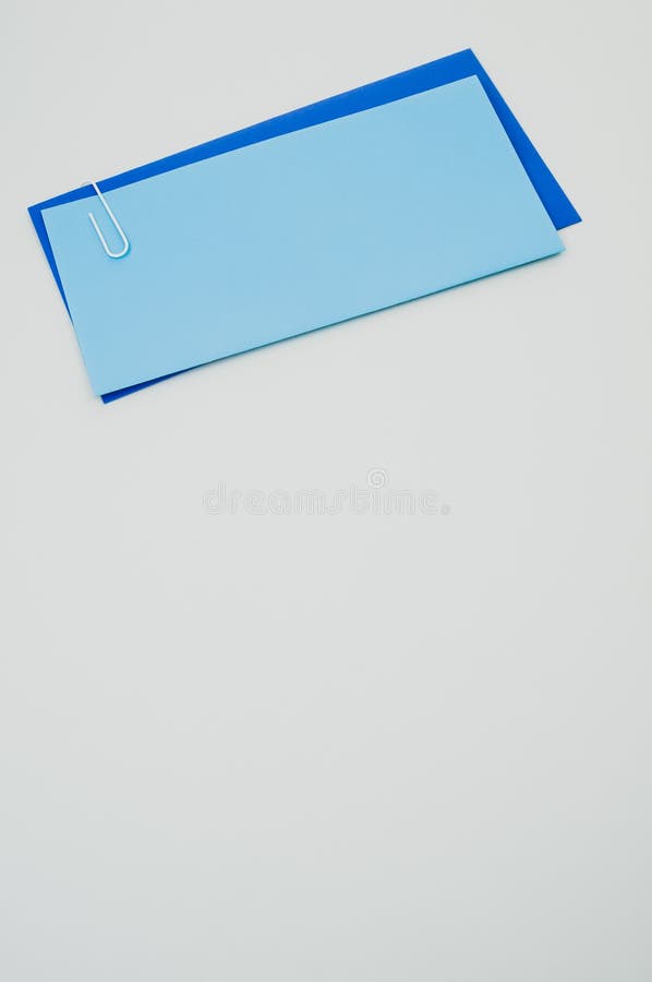 Vertical Shot of Pieces of Paper Attached with a Paper Clip on a Gray ...