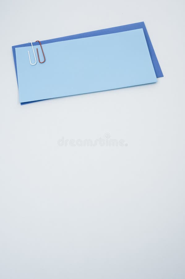 Vertical Shot of Pieces of Paper Attached with Paper Clips on a Gray ...