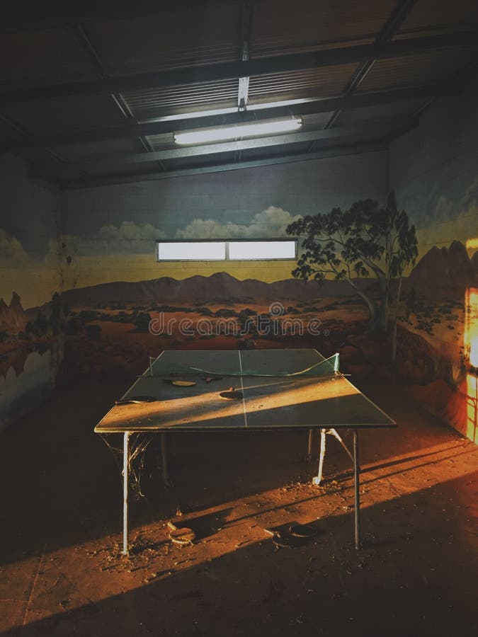 Vertical Shot of Ping Pong Table in a Room Withdrawing on a Wall and ...