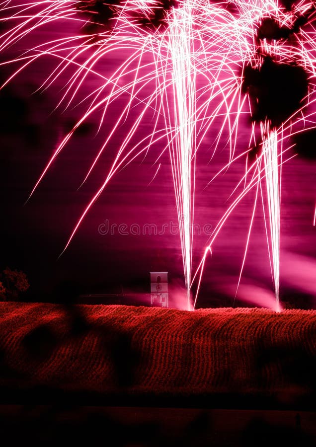 Vertical Shot of Pink Fireworks Glaring Up in the Night Sky Stock Photo ...