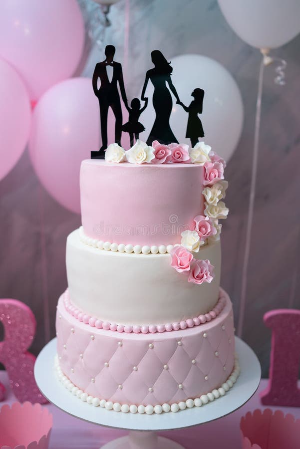 Vertical Shot of a Pink and White Cake with a Family Topper Stock Image ...