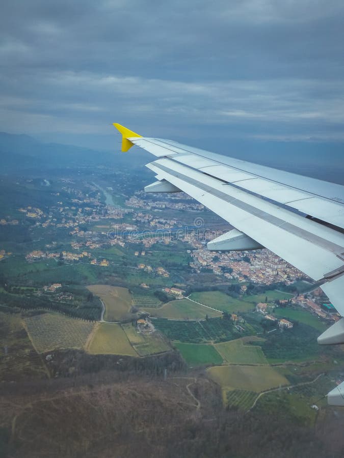 Vertical Shot from a Plane of Buildings Under a Cloudy Sky Stock Image ...