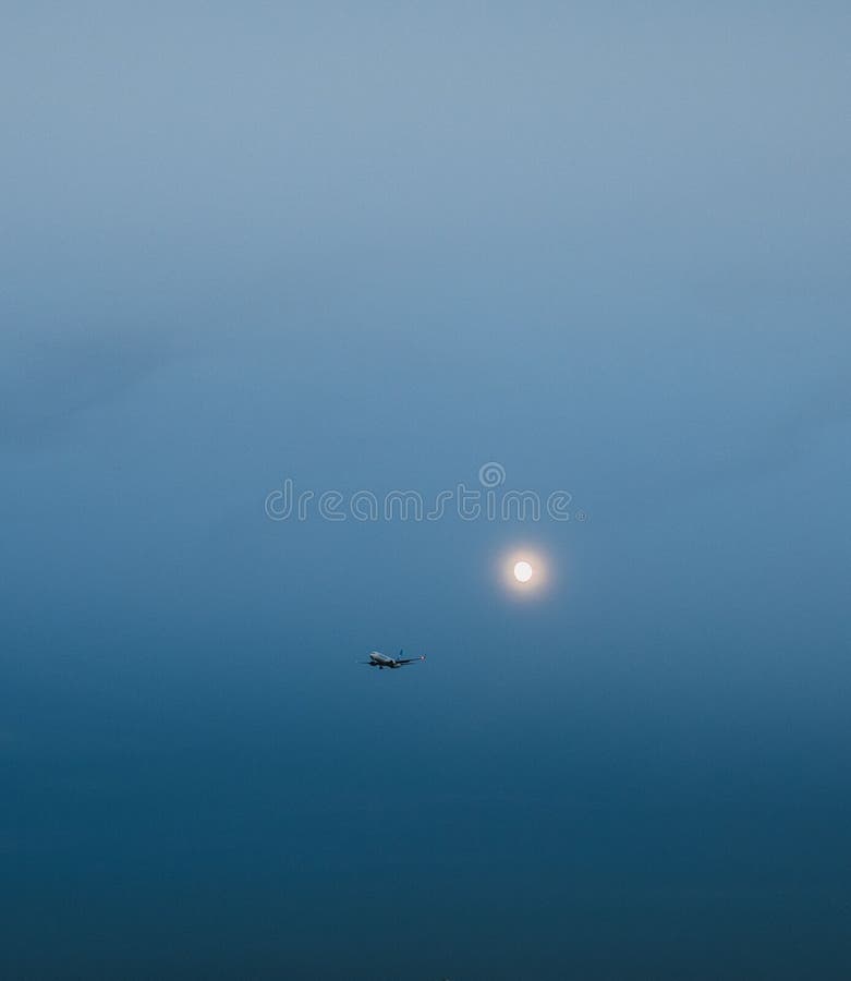 Vertical Shot of a Plane Flying in the Cloudy Sky Stock Photo - Image ...