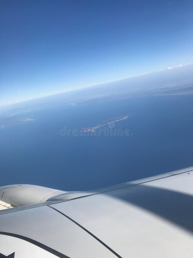Vertical Shot of a Plane Wing Flying Above the Sea on a Sunny Day Stock ...