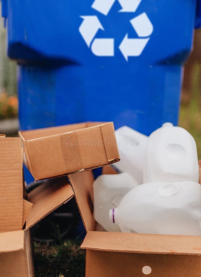 Vertical Shot of Plastic and Cardboard Boxes Placed Next To a Blue ...