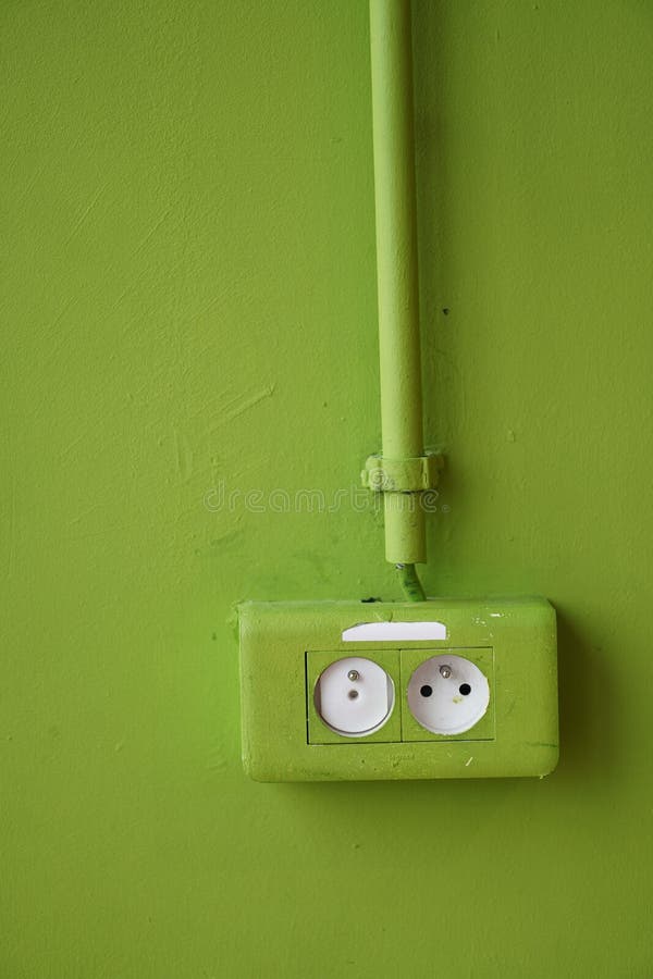 Vertical Shot of a Plug on a Green Wall Stock Image - Image of power ...