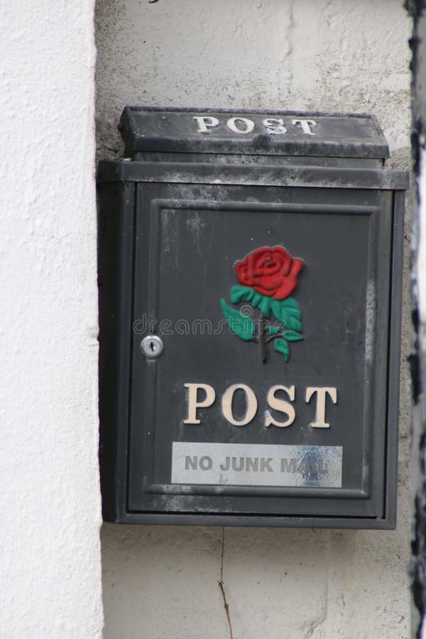 Vertical Shot of a Post Box with a Red Rose Symbol and Text Hanging ...