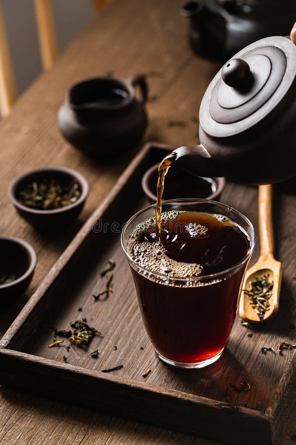 Vertical Shot of Pouring Black Tea with the Kettle Stock Image - Image ...