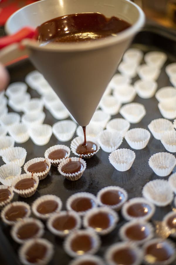 Vertical Shot of the Process of Making the Chocolate- Filling the Paper ...