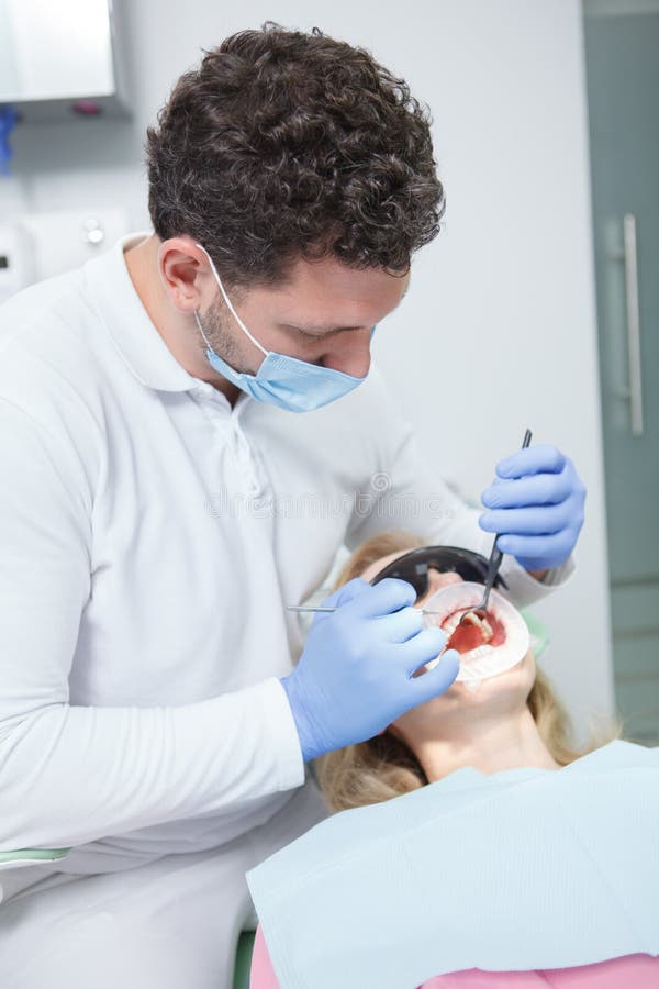 Professional Dentist Treating Teeth of Patient Stock Image - Image of ...