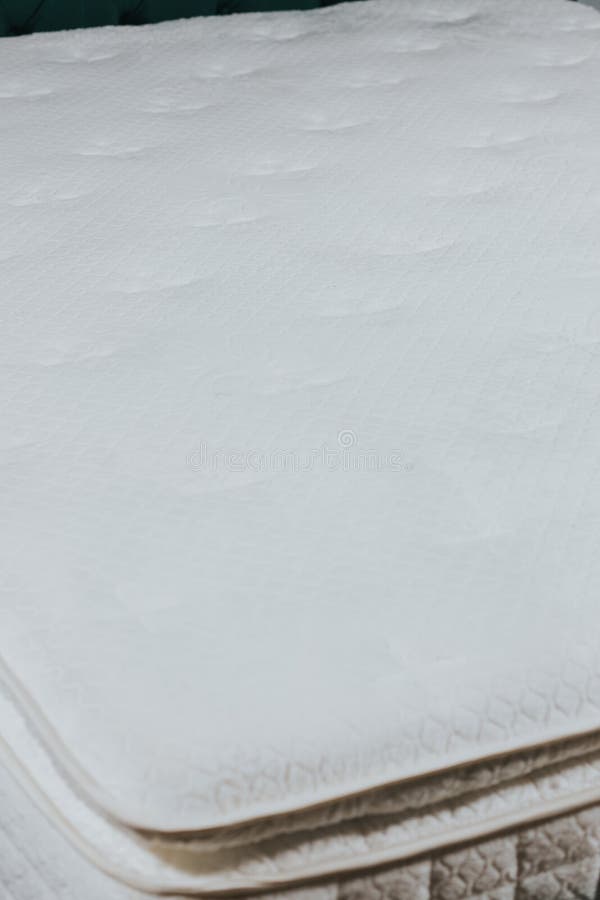 Vertical Shot of a Quilted White Mattress with Soft Flowers Pattern ...