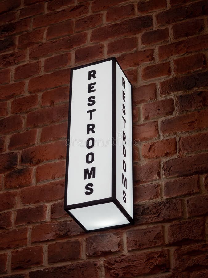 Vertical Shot of a Rectangular "RESTROOMS" Sign with White Led Lights ...