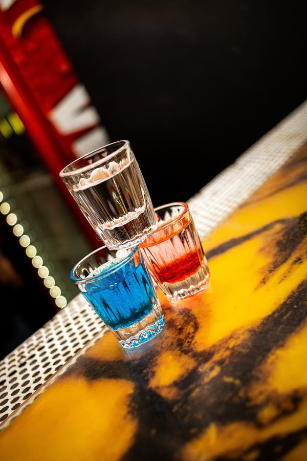 Vertical Shot of Red Blue and Transparent Drinks on the Bar Stand Stock ...