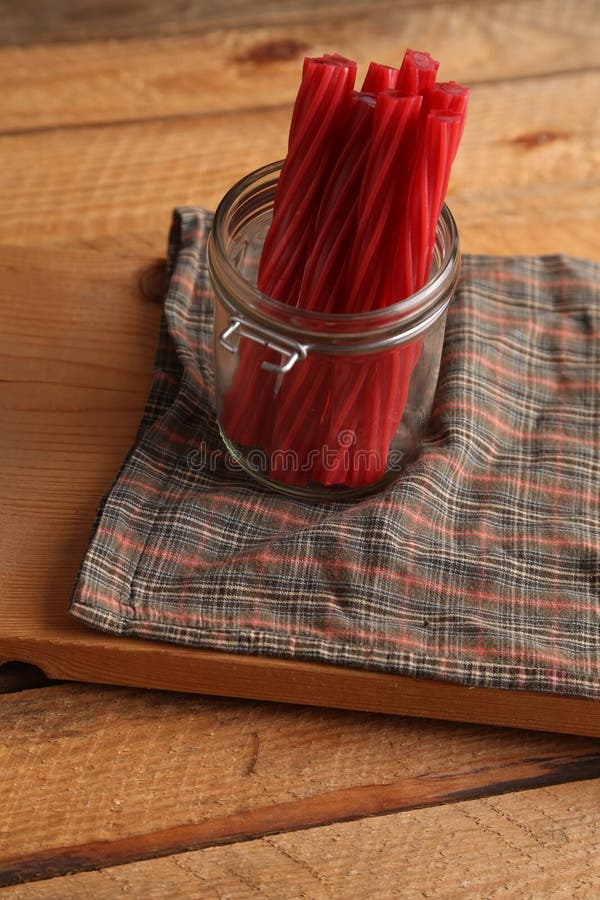 Vertical Shot of Red Candy Sticks in a Jar on a Wooden Board Stock ...