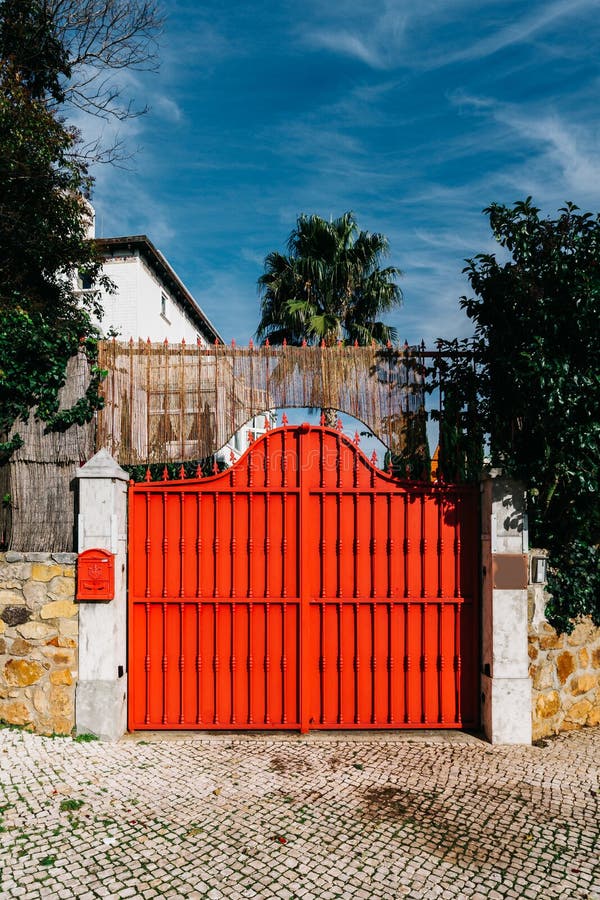 Vertical Shot of a Red Gate of a Private House Stock Photo - Image of ...