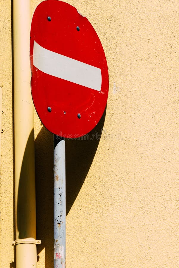 Vertical Shot of Red No Entry Sign Pole Leaning on Peach Building Stock ...