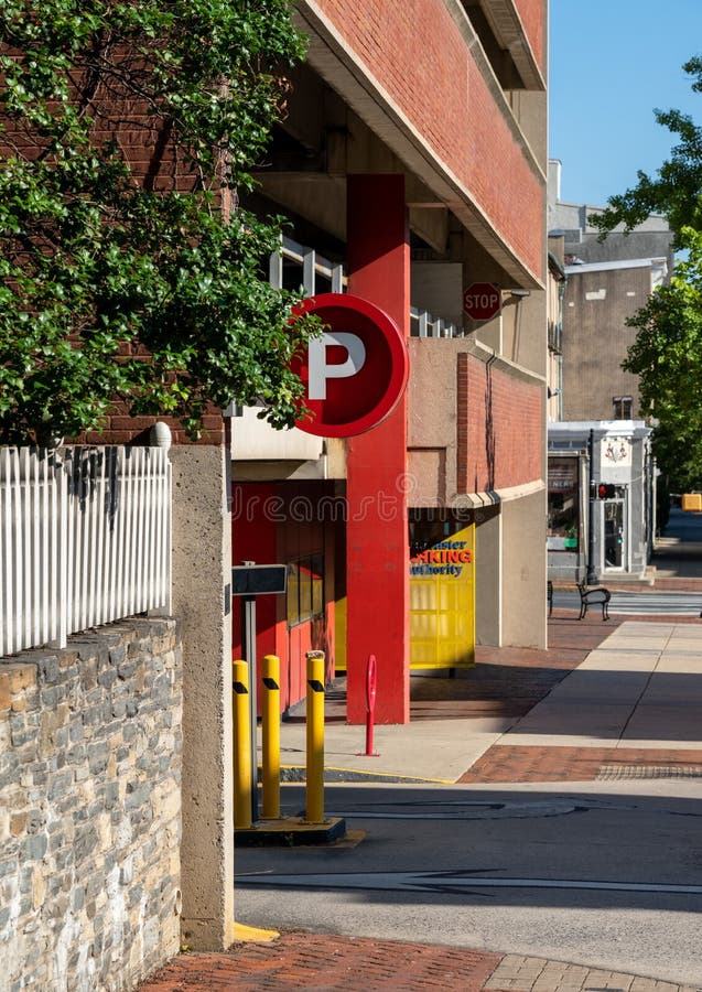 Vertical Shot of a Red Parking Garage Sign Hanging Outside the Parking ...