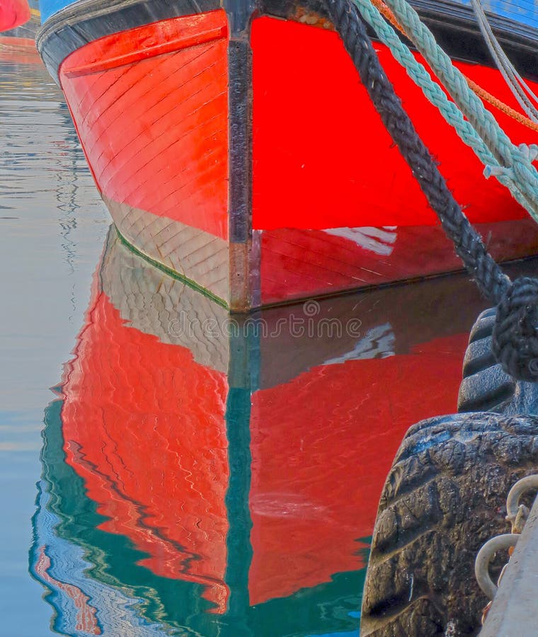 Vertical Shot of a Red Ship Reflecting in the Sea at the Harbor Stock ...