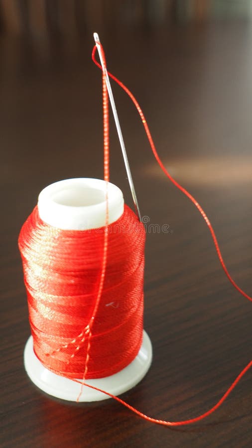 Vertical Shot of Red Thread and a Needle Stock Photo - Image of thread ...