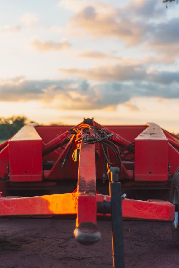 Vertical Shot of a Red Tractor in a Cultivated Field at Sunset Stock ...