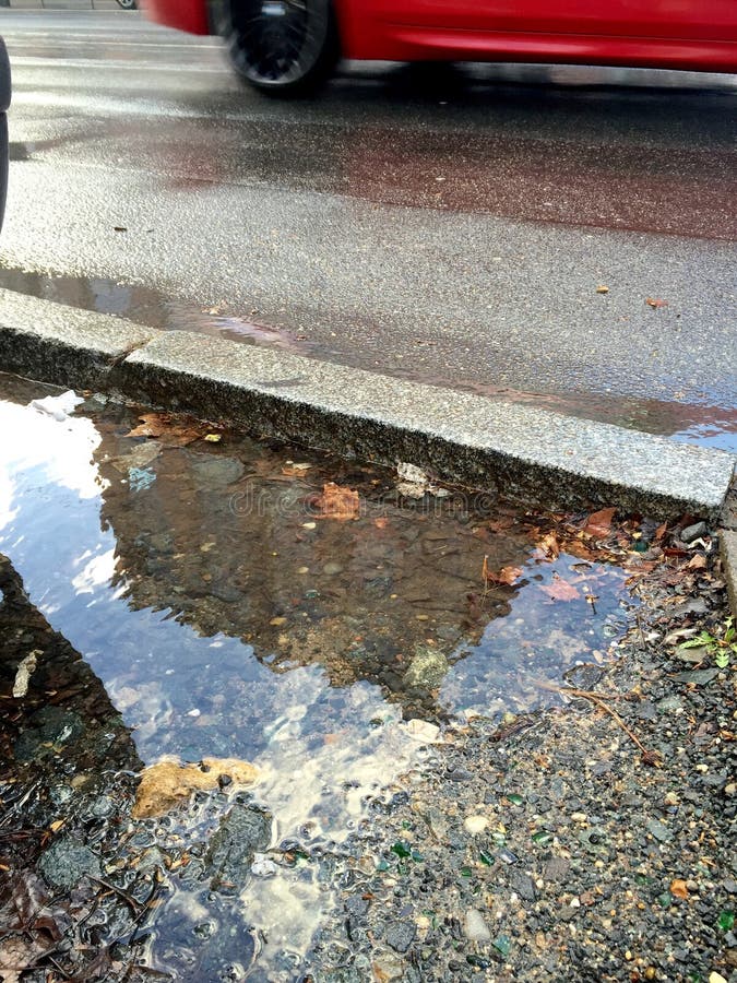 Vertical Shot of a Reflection of a Building through the Water Next To ...