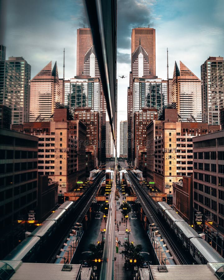 Vertical Shot of the Reflection of High Rise Building and a Train on ...
