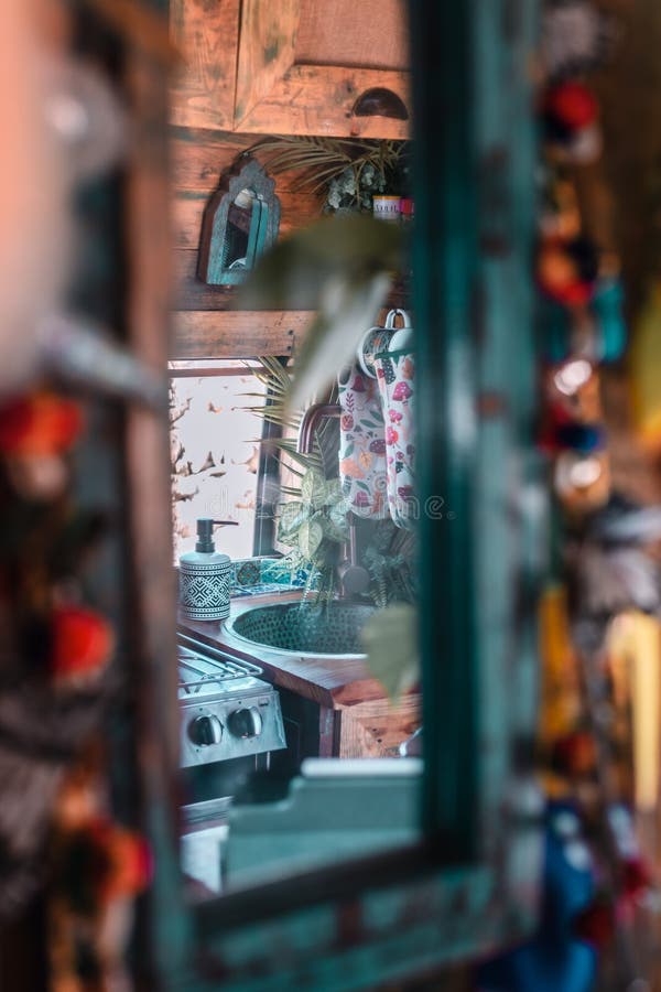Vertical Shot of the Reflection of Rustic Kitchen Interior in the ...