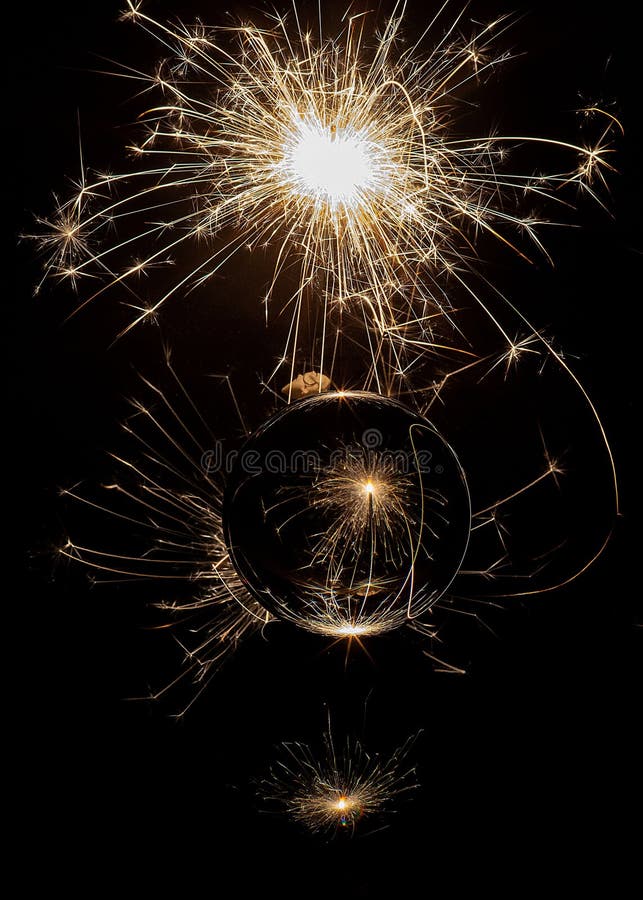 Vertical Shot of a Reflective Glass Ball in Front of Exploding Colorful ...