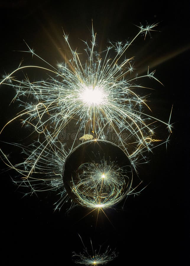 Vertical Shot of a Reflective Glass Ball in Front of Exploding Colorful ...