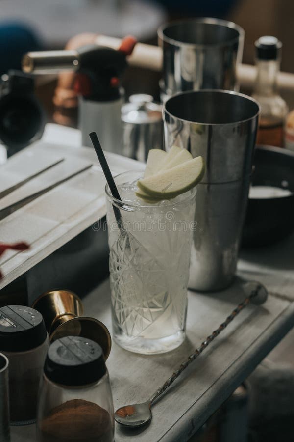 Vertical Shot of Refreshing Summer Cocktail with Ice on a Bar Table ...