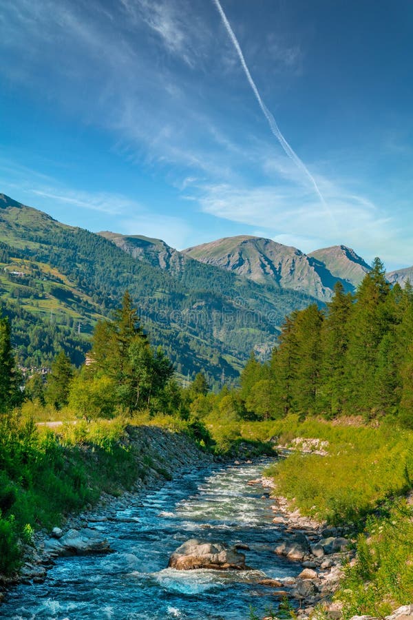 Vertical Shot of a River on Background of Fir Trees and Mountains Stock ...