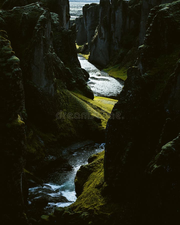 Vertical Shot of a River Flowing between Mossy Cliffs Stock Photo ...