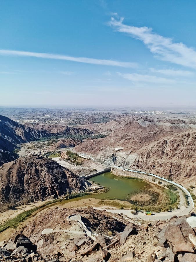 Vertical Shot of a River Flows between Rough Landscapes in the Daytime ...